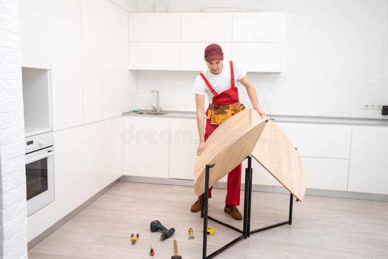 Young Man Assembling Kitchen Furniture. Stock Photo - Image of manual ...