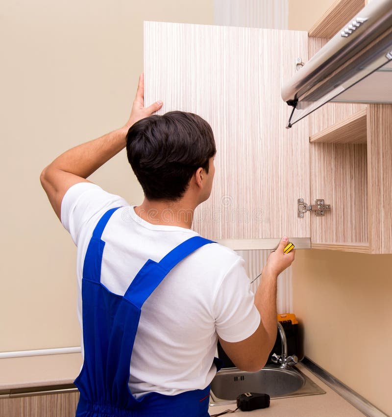 Young Man Assembling Kitchen Furniture Stock Image - Image of holding ...