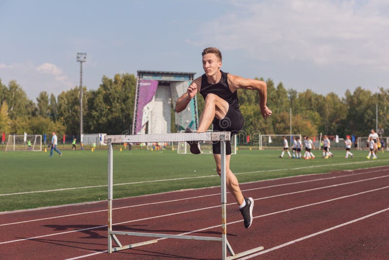 Young Man Athlete Runnner Running Hurdles Stock Photo - Image of ...