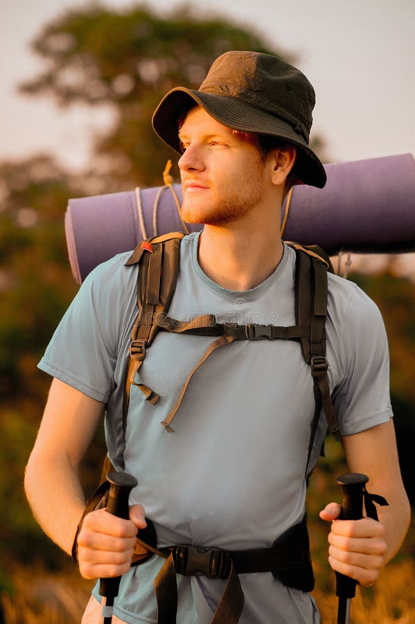 A Young Man with Backpack Going Hiking and Carrying His Backpack and a ...