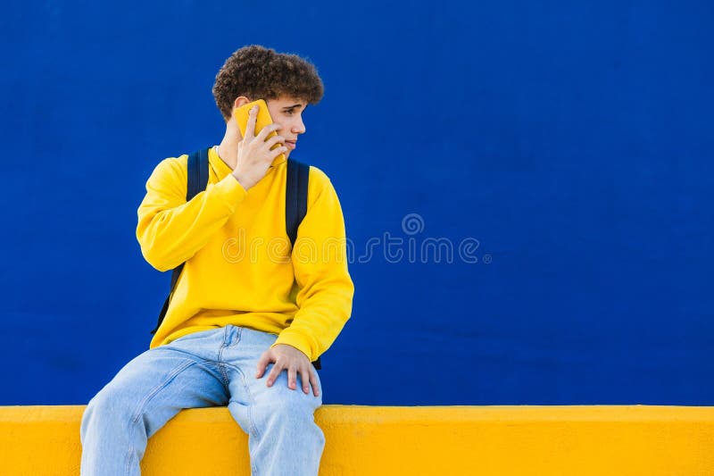 College Student Using Smartphone Sitting Yellow Wall Blue Background ...