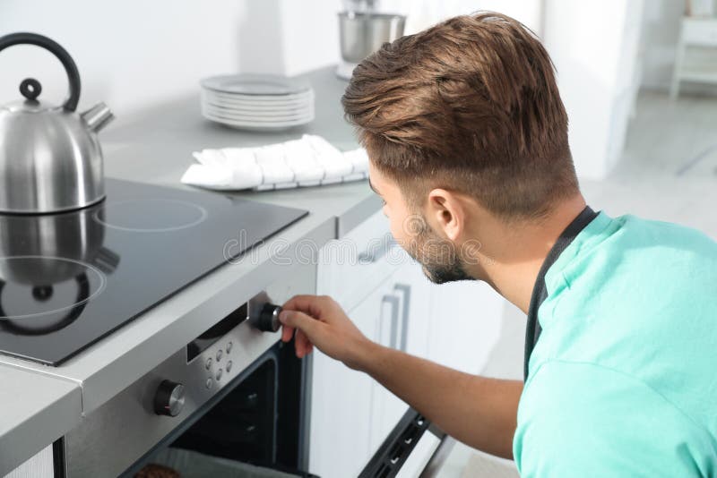 Man Cooking Something Oven Stock Photos - Free & Royalty-Free Stock ...