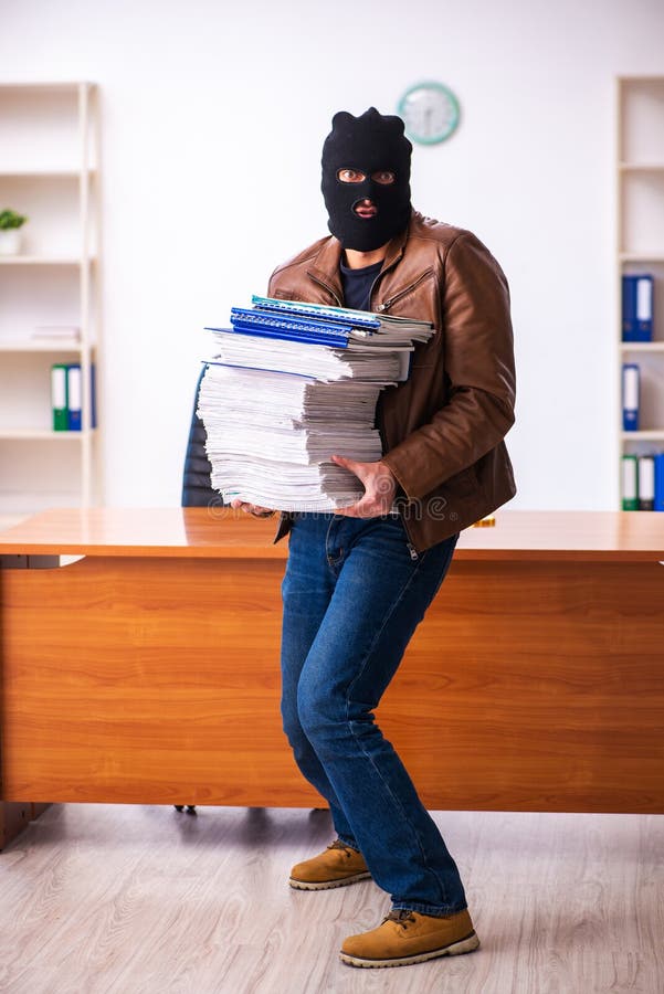 Young Man in Balaclava Stealing Information from the Office Stock Photo ...