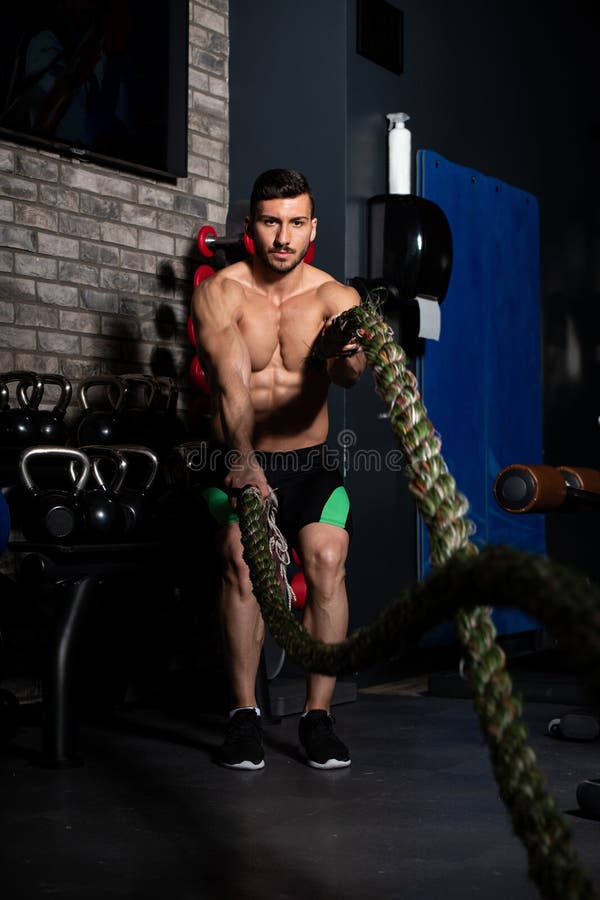 Young Man Battling Ropes at Gym Workout Exercise Stock Photo - Image of ...
