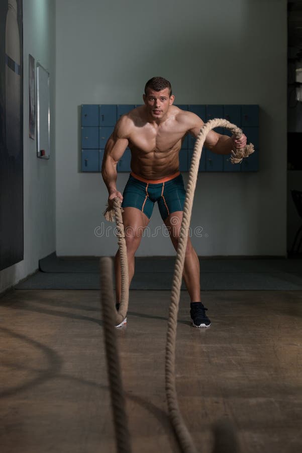 Young Man Battling Ropes at Gym Workout Exercise Stock Image - Image of ...