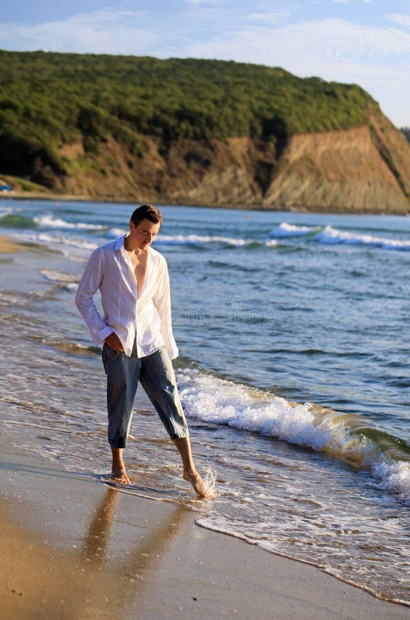 Young man at the beach stock image. Image of outdoor - 25455105