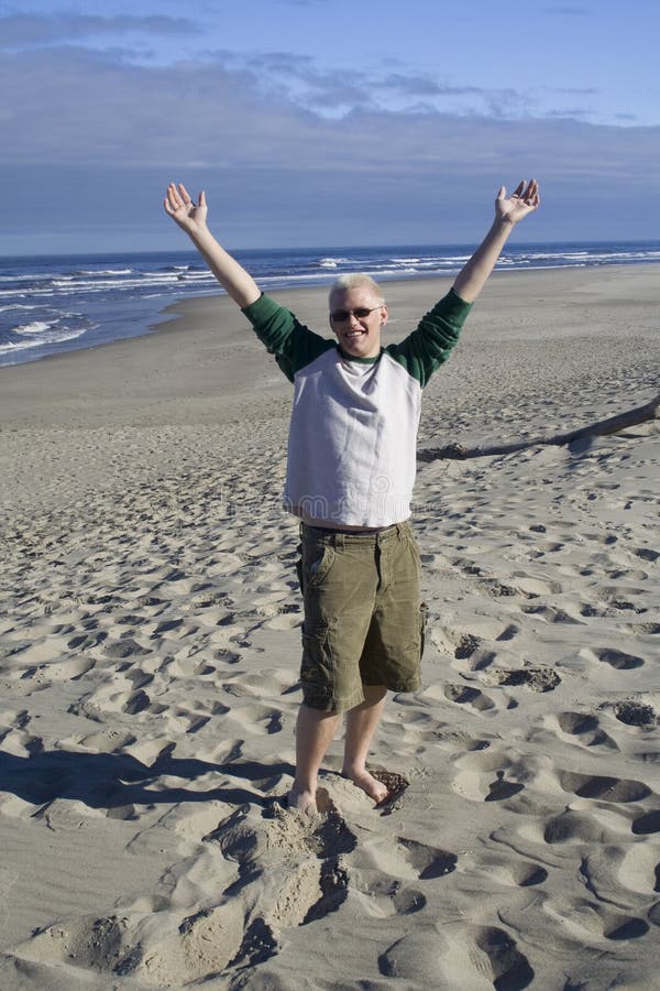 Young man at the beach stock photo. Image of beach, sand - 5872926