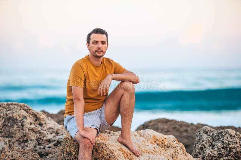 Young Man Relaxing on the Beach at Sunset Stock Photo - Image of sand ...