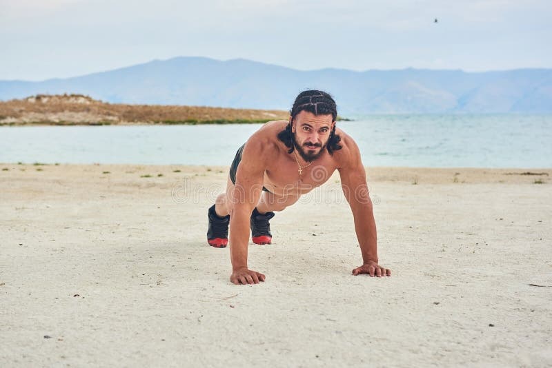 Young Man on the Beach, Young Muscular Man Exercising on the Beach ...