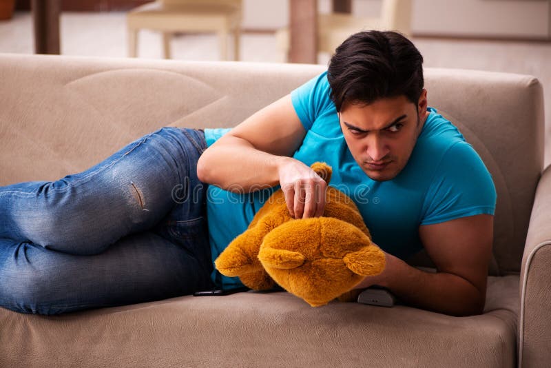Young Man Sitting with Bear Toy at Home Stock Photo - Image of male ...