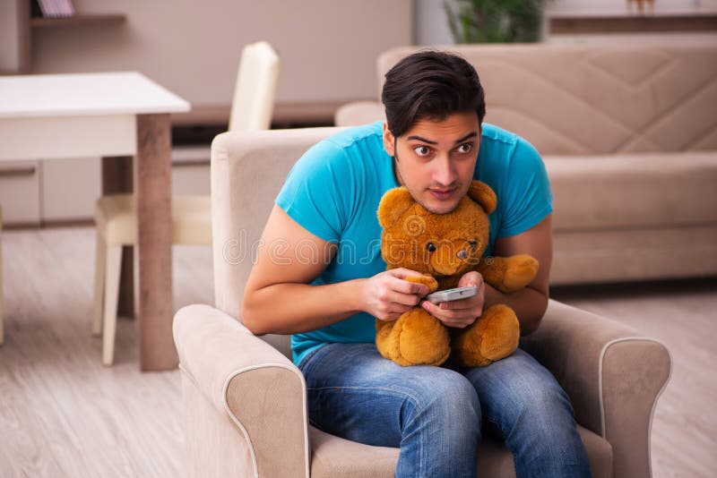 Young Man Sitting with Bear Toy at Home Stock Image - Image of pandemic ...