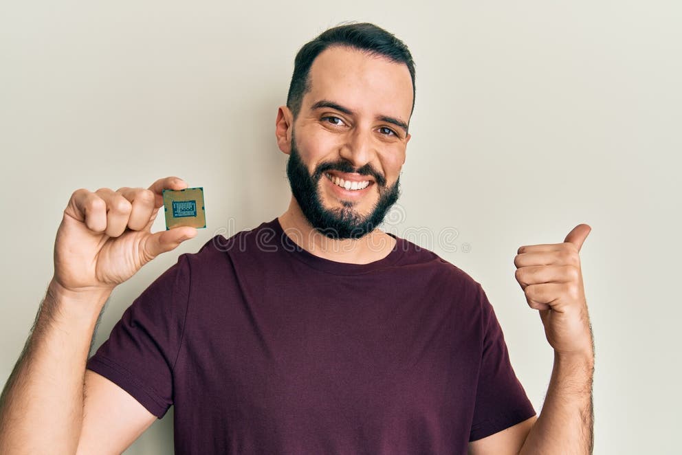 Young Man with Beard Holding Cpu Computer Processor Pointing Thumb Up ...