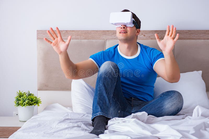 The Young Man in Bed Wearing a Vr Virtual Reality Head Set Stock Photo ...