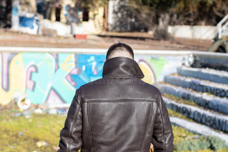 Young Man from Behind with Leather Jacket in an Abandoned Space Stock ...