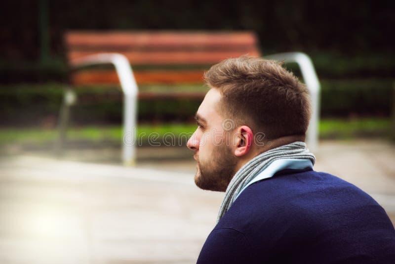 Young Man from Behind Sitting in Park Looking into Infinity Stock Image ...