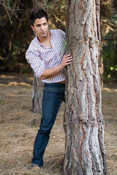 Young man behind a tree stock image. Image of country - 6132323
