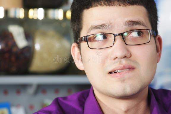 Young man biting own lip stock image. Image of purple - 13887161