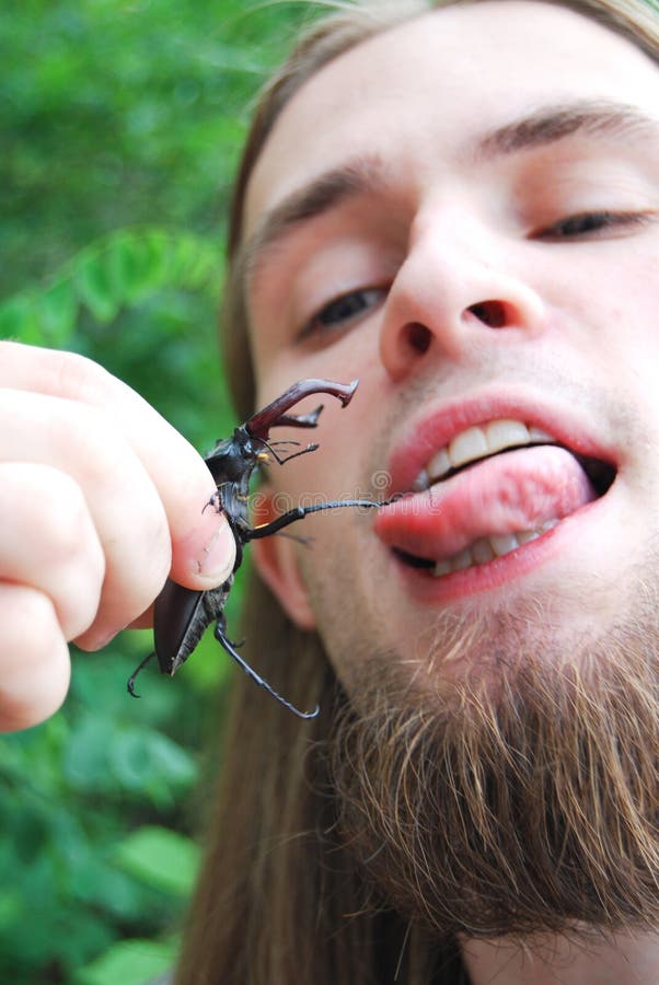 Young Man with a Black Beetle Stock Image - Image of metal, intense ...