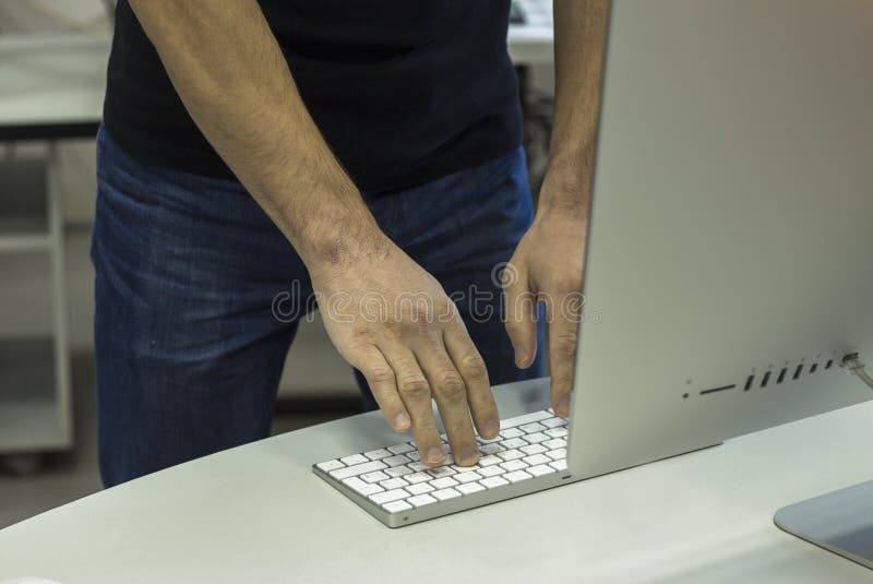 Young Man in a Black T-shirt Working with Computer, Standing Stock ...