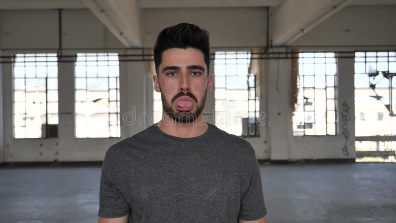 Young Man Blowing Raspberry To Camera Stock Video - Video of face ...