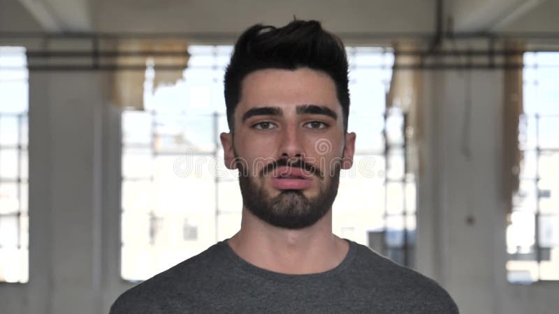 Young Man Blowing Raspberry To Camera Stock Video - Video of standing ...