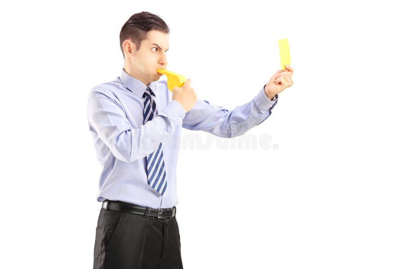 Young Man Blowing a Whistle and Showing a Yellow Card Stock Photo ...