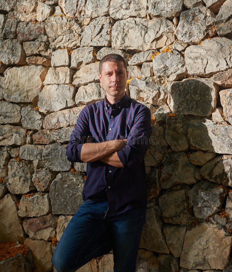 Young Man in Blue Shirt Posing Behind a Wall Stock Photo - Image of ...