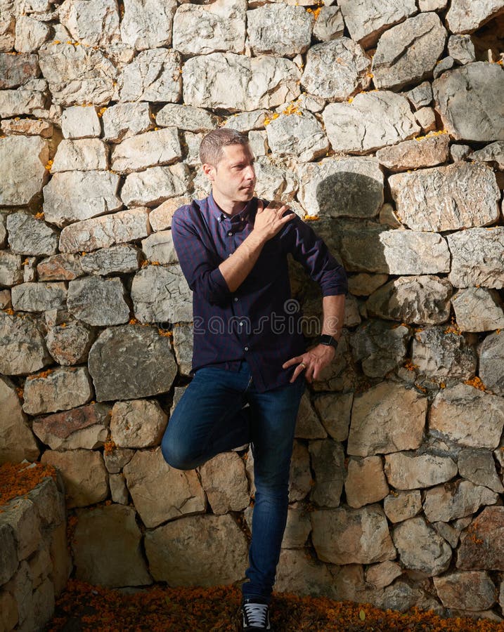 Young Man in Blue Shirt Posing Behind a Wall Stock Photo - Image of ...