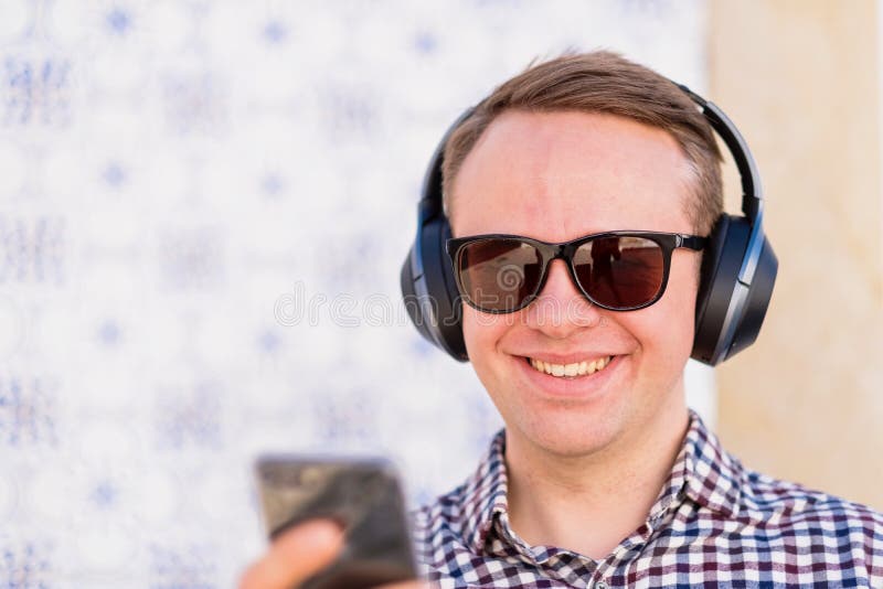 Young Man with Bluetooth Headphones Connected To Smartphone Stock Image ...