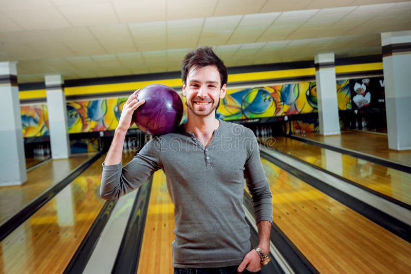 Young Man at the Bowling Alley with the Ball. Stock Photo - Image of ...