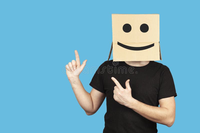 Young Man with Box on His Head with Emoji Smile Points His Finger To ...