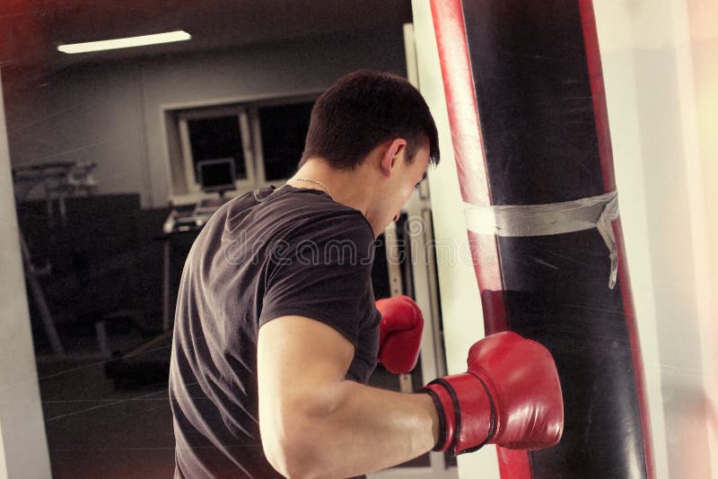 A Young Man is Boxing a Bag Stock Photo - Image of beautiful, fighter ...