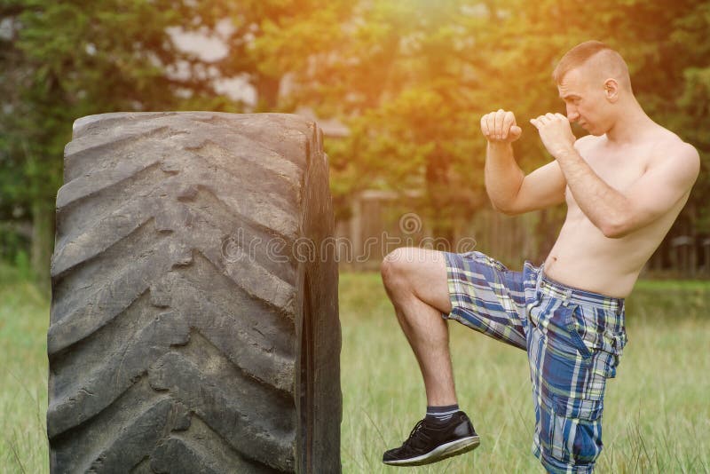 Young Man Boxing with the Tire. Workout Stock Image - Image of athletic ...