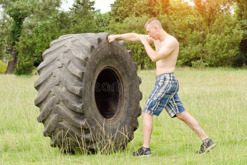 Young Man Boxing with the Tire. Workout Stock Image - Image of athletic ...