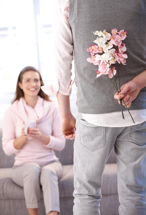 Young Man Bringing Flowers To Woman Stock Photo - Image of blossom ...