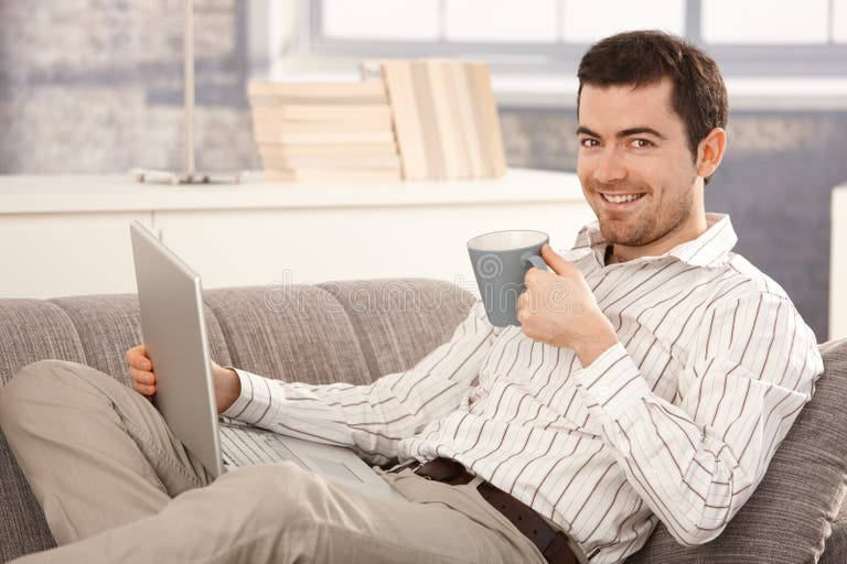 Young Man Browsing Internet at Home Smiling Stock Photo - Image of ...
