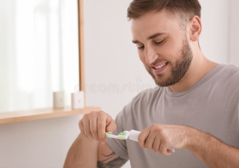 Young Man Brushing Teeth in Bathroom Stock Image - Image of person ...