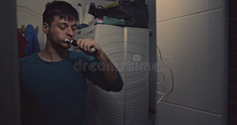Young Man Brushing Teeth in Bathroom: Morning Routine and daily Hygiene ...