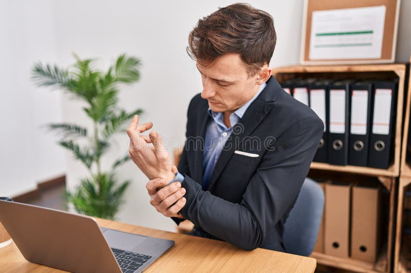 Young Man Business Worker Suffering for Wrist Pain Working at Office ...