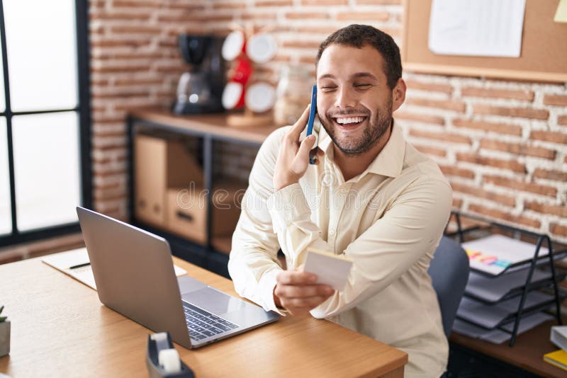Young Man Business Worker Talking on Smartphone Reading Reminder Paper ...
