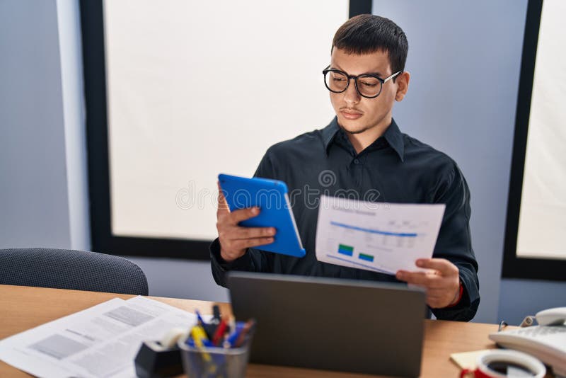Young Man Business Worker Using Touchpad Reading Document at Office ...
