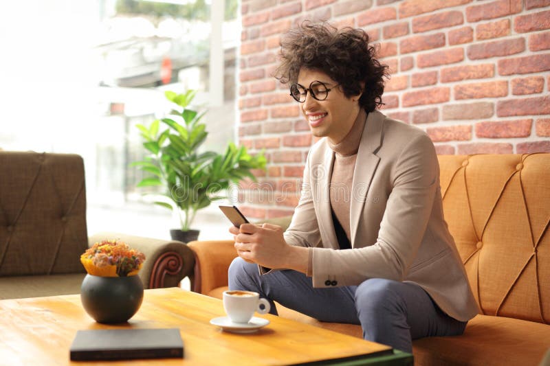 Young Man in a Cafe Holding a Mobile Phone Stock Photo - Image of model ...