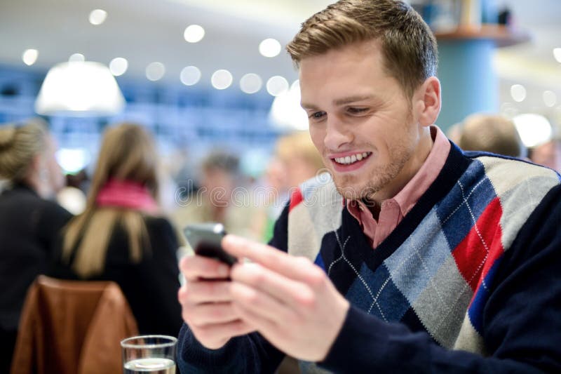 Young Man in Cafe and Using His Mobile Phone Stock Image - Image of ...