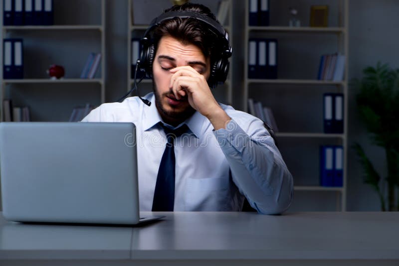 Young Man in Call Center Concept Working Late Overtime in Office Stock ...