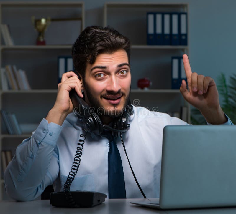 Young Man in Call Center Concept Working Late Overtime in Office Stock ... Young Man in Call Center Concept Working Late Overtime in Office Stock ...