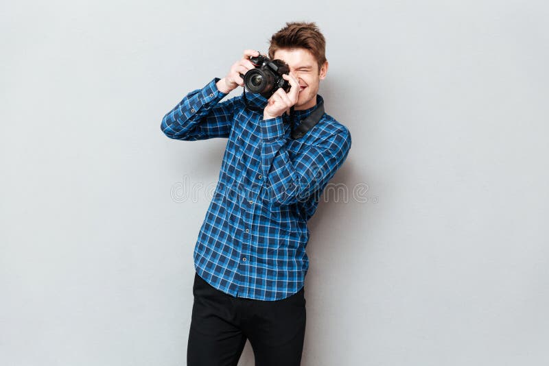 Young Man with Camera Making Photo Stock Photo - Image of shots ...