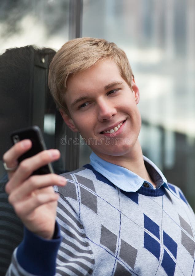 Young man with cameraphone stock photo. Image of texting - 12373582