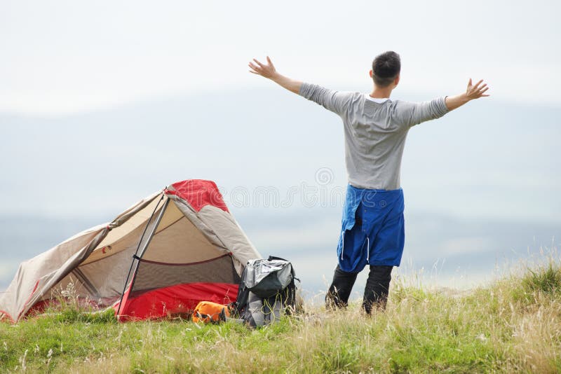 Young Man on Camping Trip in Countryside Stock Photo - Image of people ...