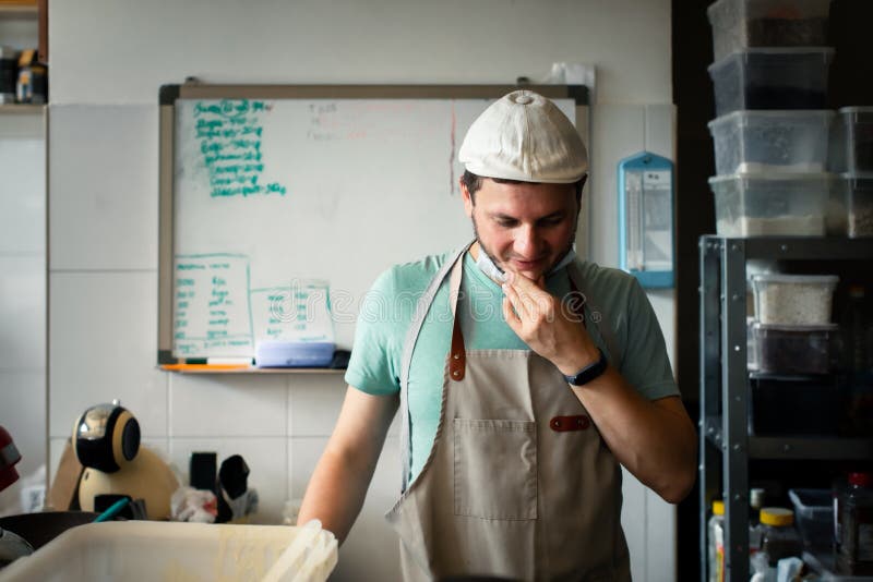 A Young Man in a Cap and Apron at the Baker& X27;s Job. Problem Solving ...