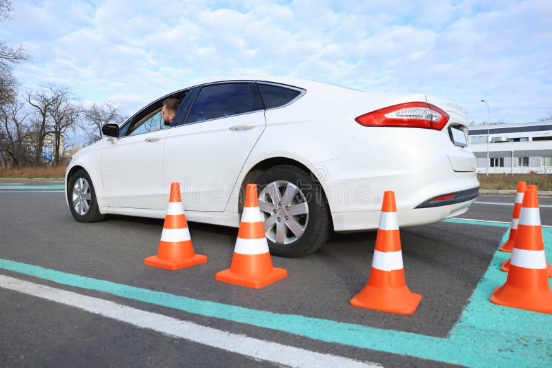 Young Man in Car on Test Track with Traffic Cones. Driving School Stock ...